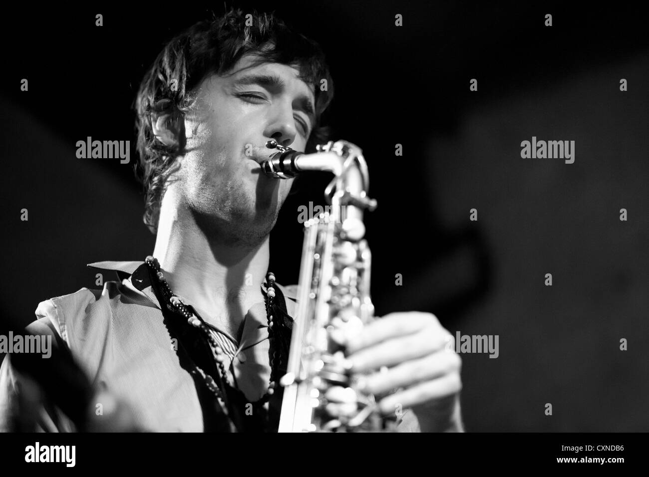 man playing a saxophone on stage at a gig Stock Photo - Alamy