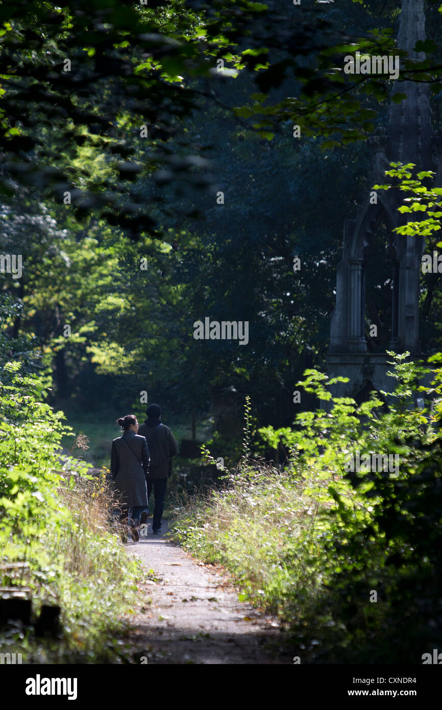 A Couple walking in Tower Hamlets Cemetery Park in the East End of ...
