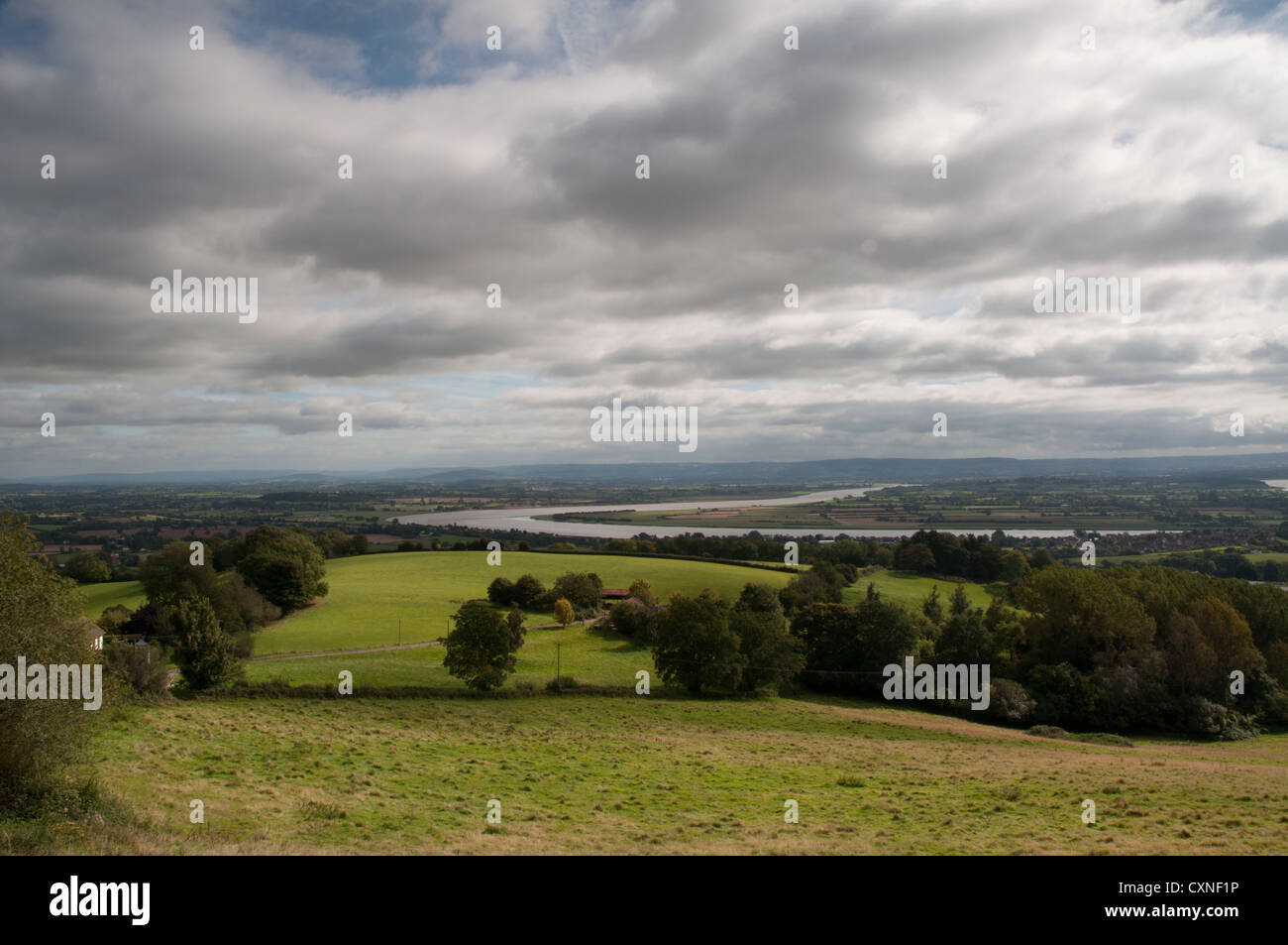 rural landscape with river in background, farmland, trees, hedges ...