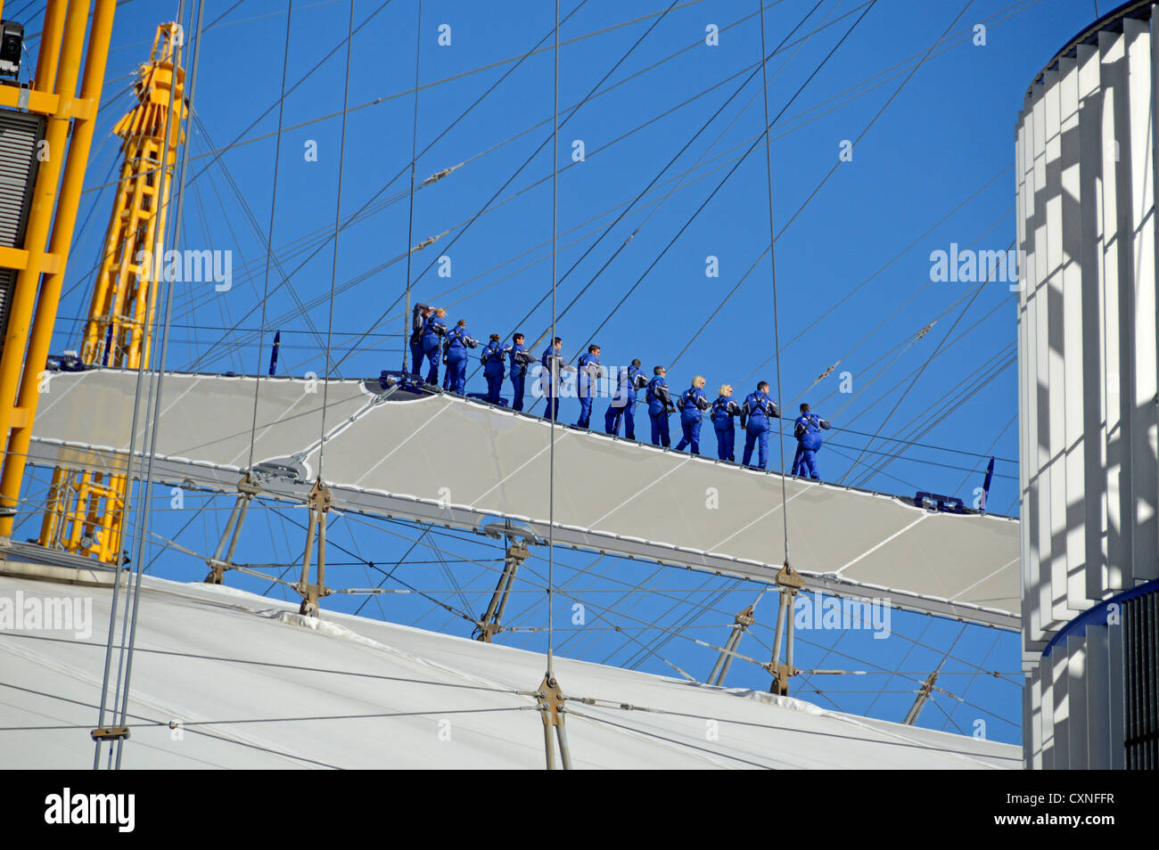 Up At The O2, people kitted out in blue overalls walking on roof of the ...