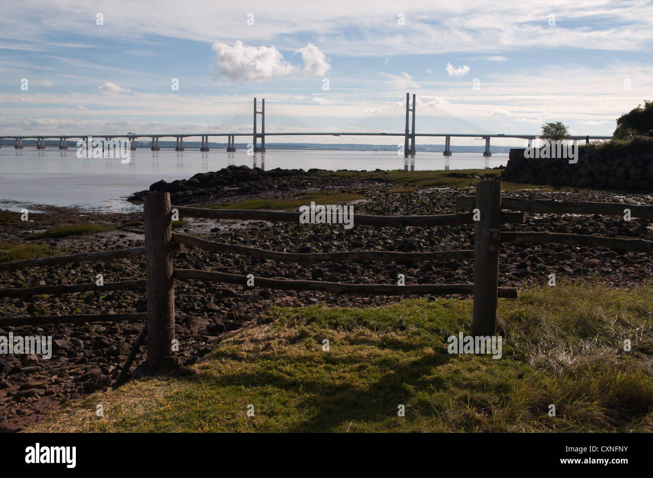 River Severn estuary at low tide with rocks, grass and mud, sunny day ...