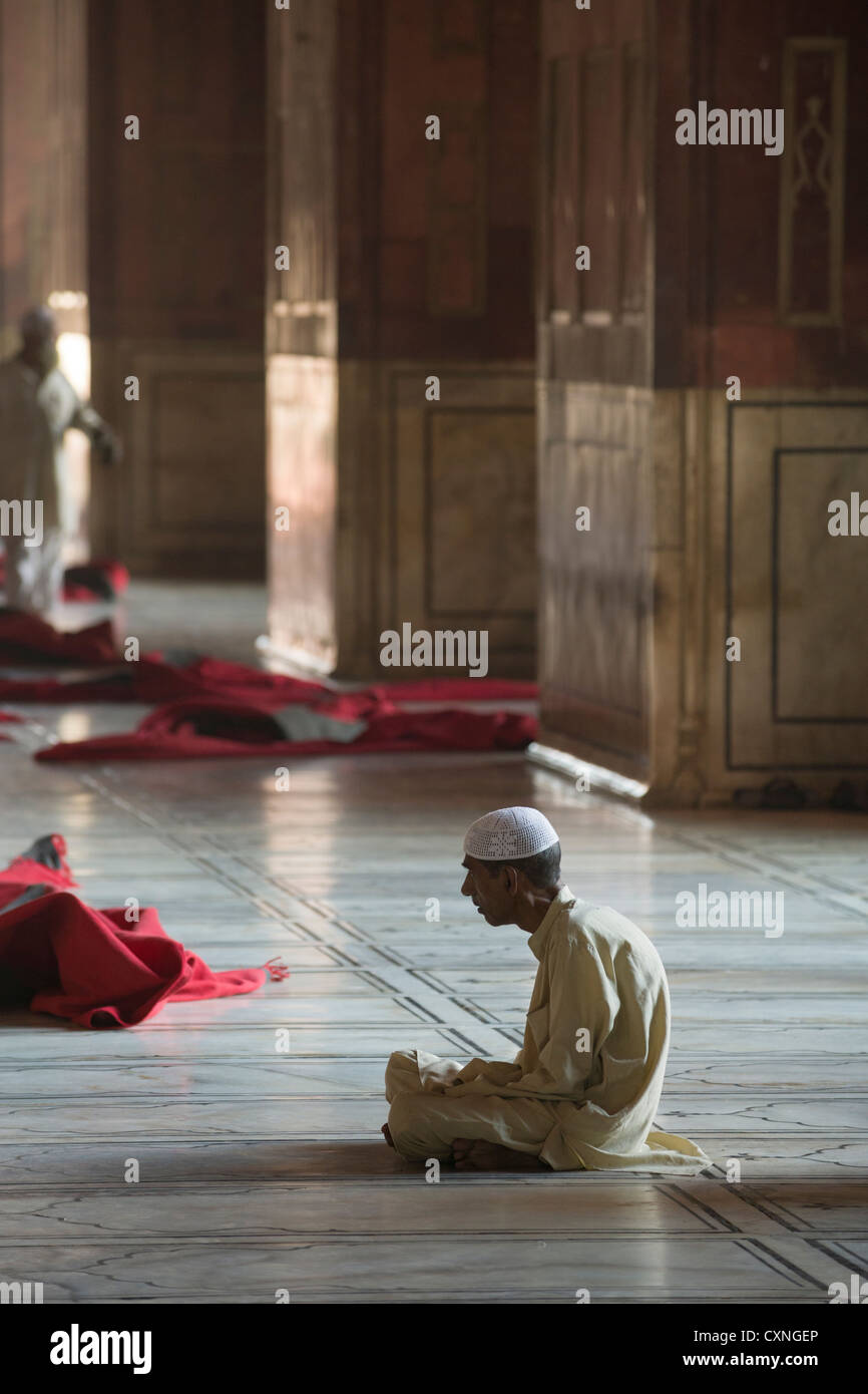 Young man praying inside the Jama Masjid main mosque, Old Delhi, India ...