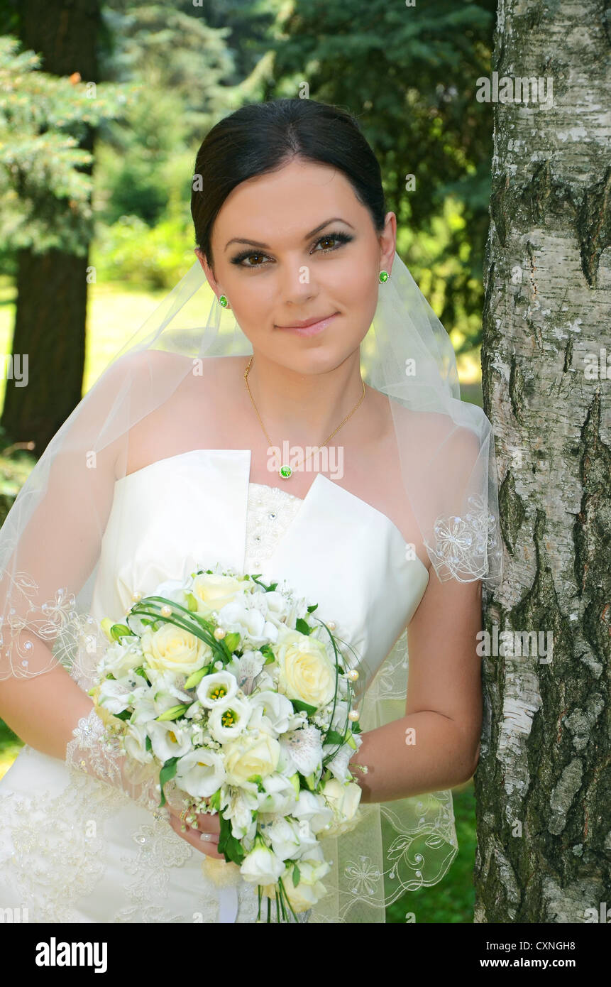 beautiful bride with a bouquet on nature Stock Photo - Alamy