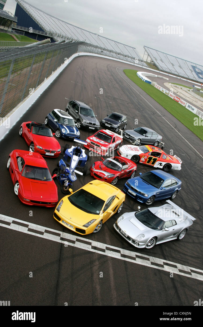 Group shot of cars and bike on race track Stock Photo - Alamy
