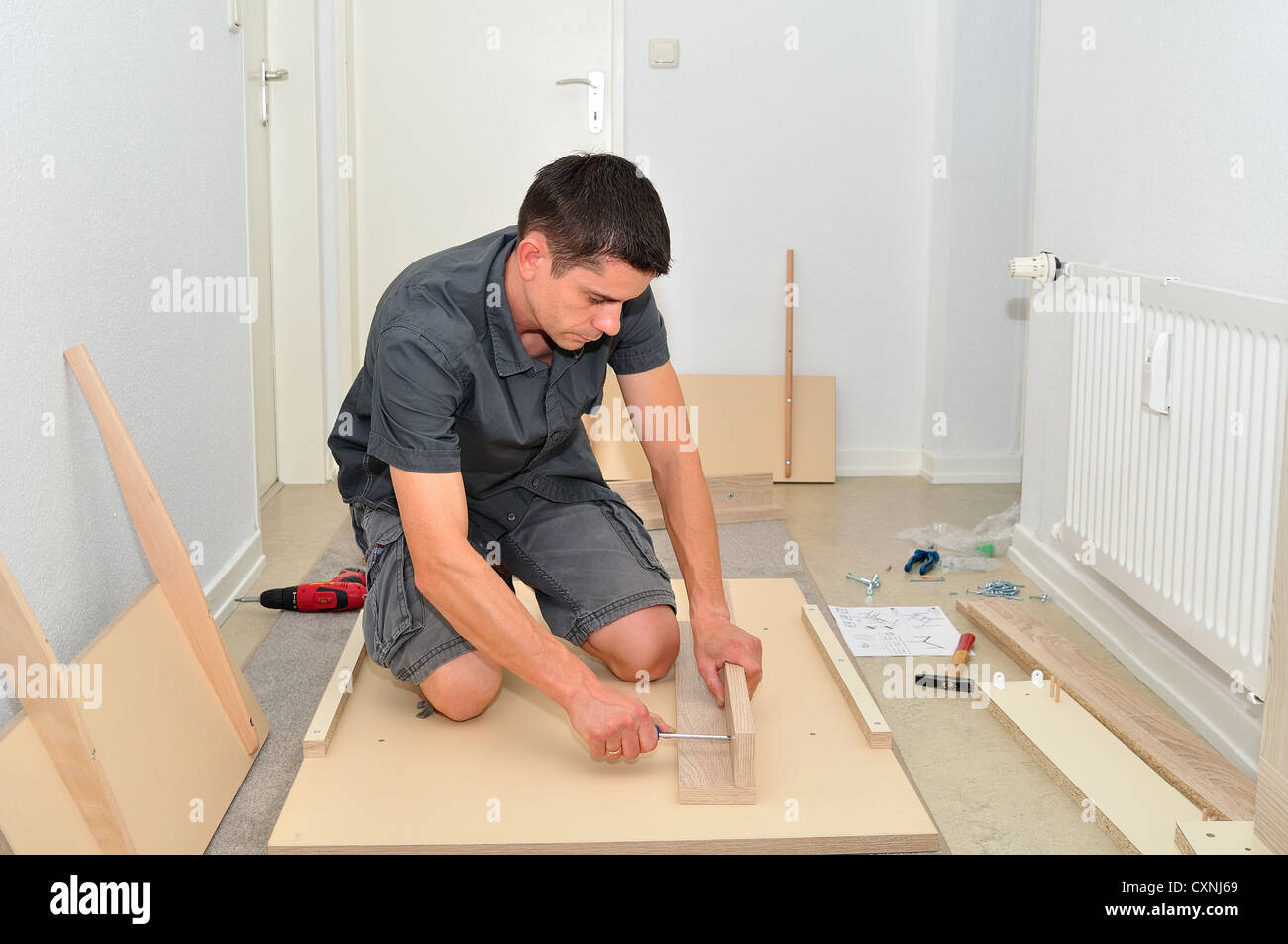 Man assembling a table Stock Photo - Alamy