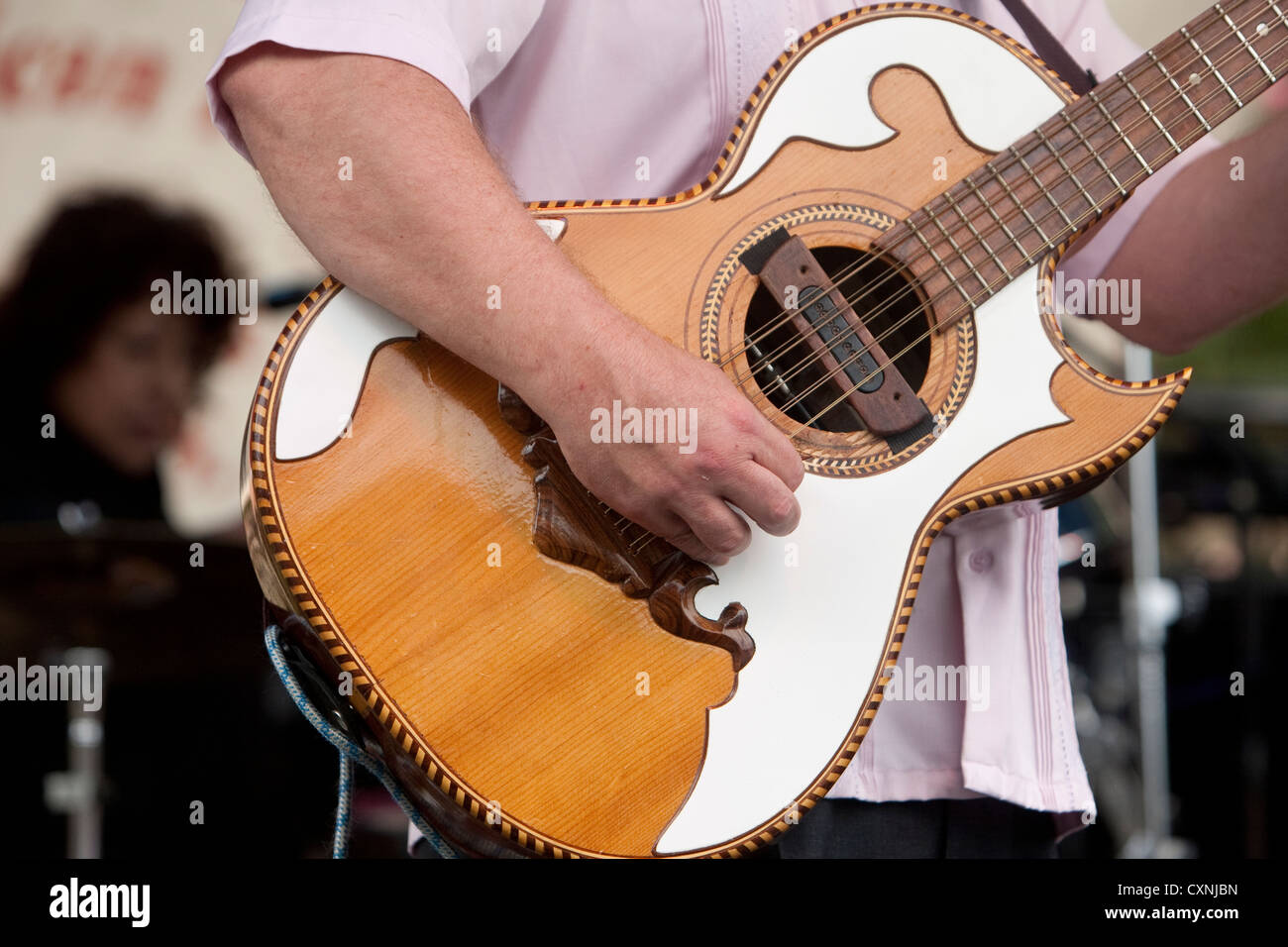 White male musician plays the guitar in a Tejano style music group at ...