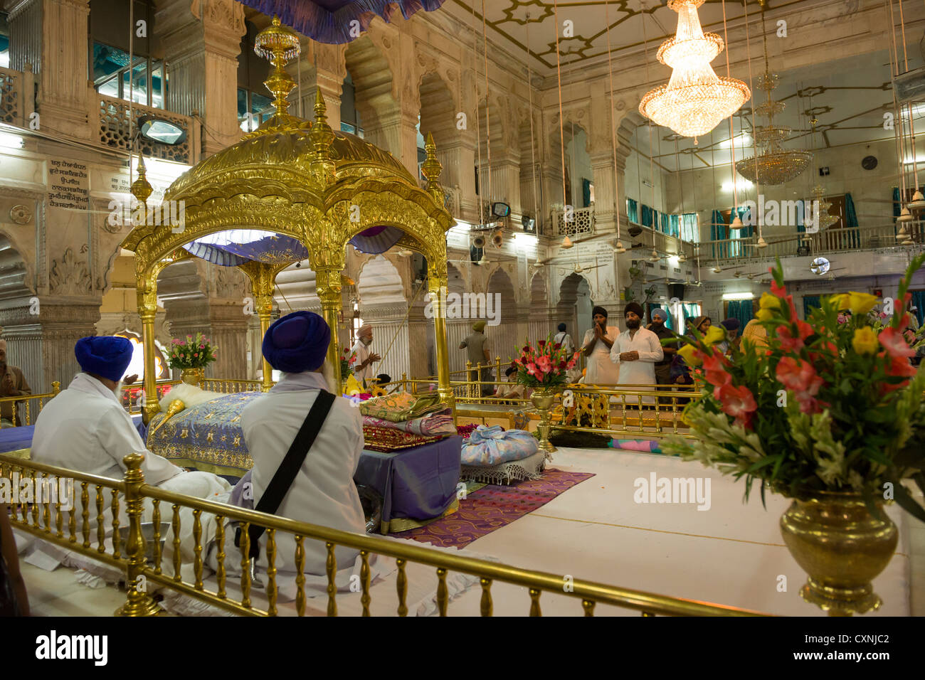Priests in the main prayer hall of the Gurudwara Sis Ganj Sahib, a Sikh ...