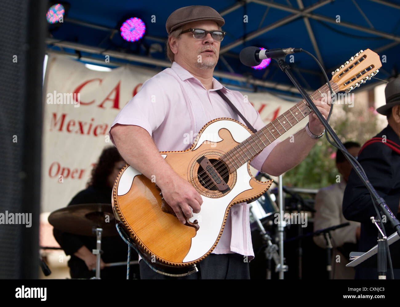 White male musician plays the guitar in a Tejano style music group at ...