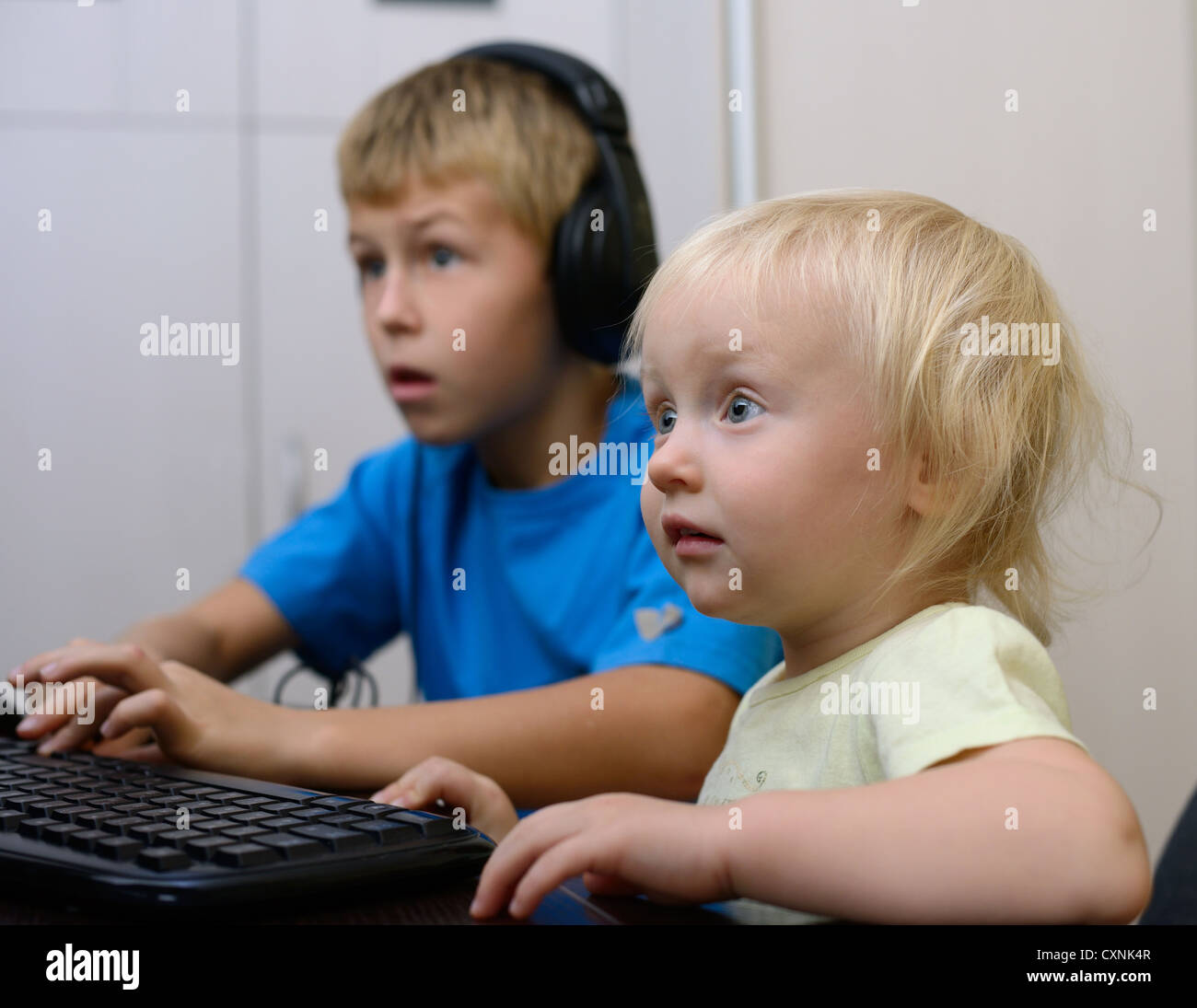 children with headphones looking at the monitor Stock Photo - Alamy