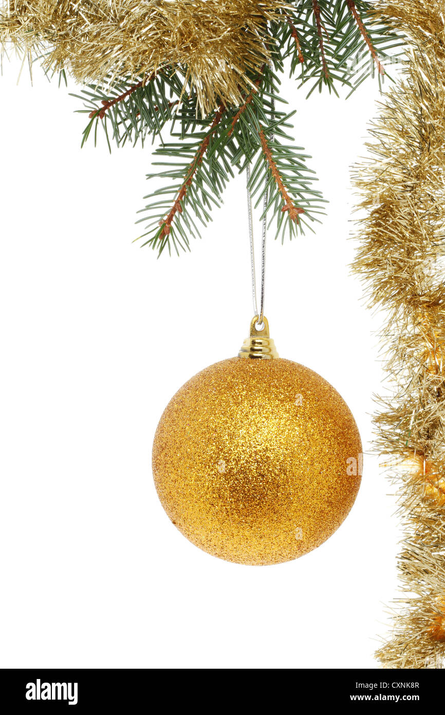 Gold Christmas ball decoration and tinsel hanging from a branch of a Christmas tree against a white background Stock Photo Alamy