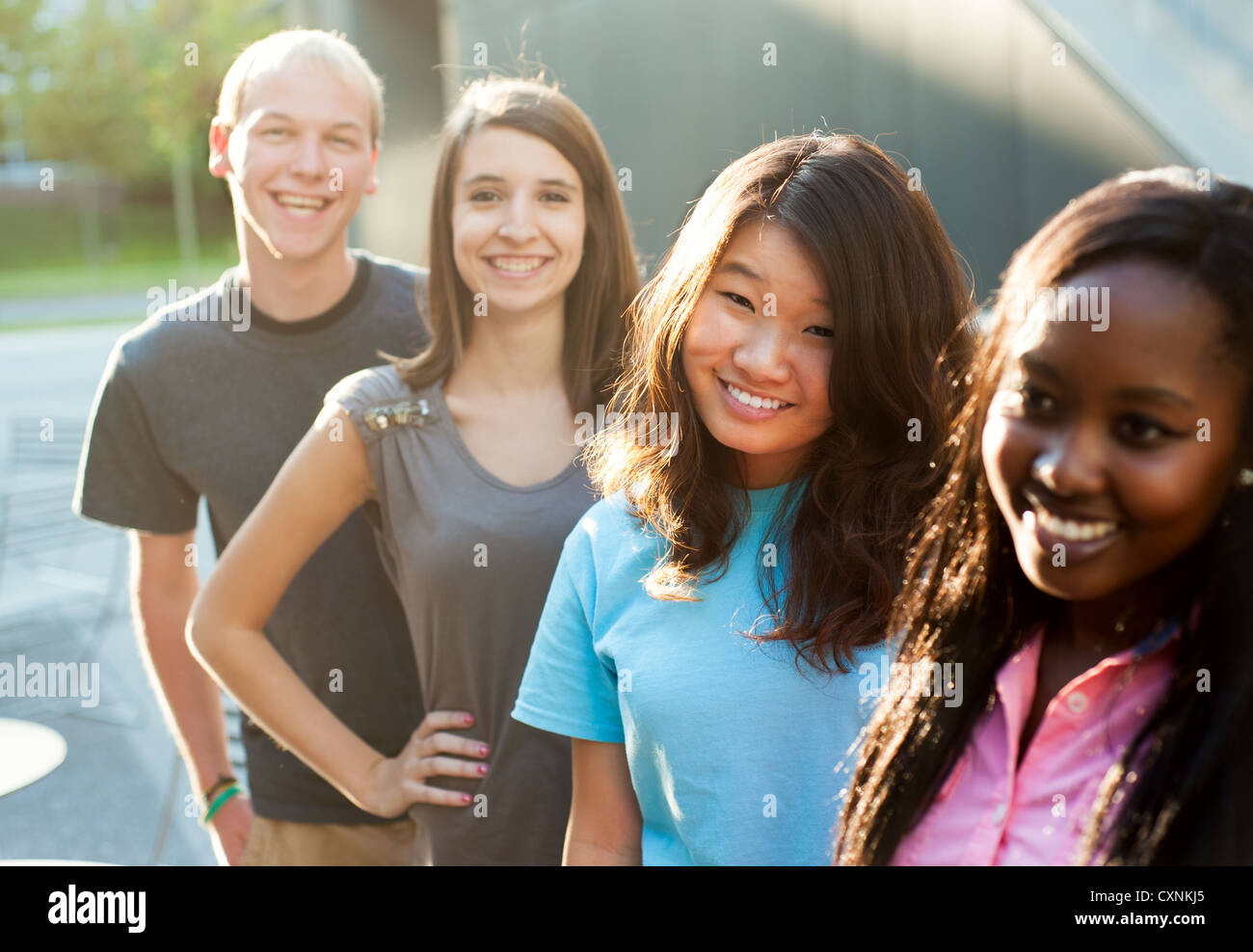 Multi-ethnic group of teenagers outside smiling Stock Photo - Alamy Multi-ethnic group of teenagers outside smiling Stock Photo - Alamy