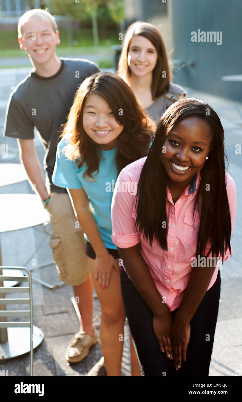 Multi-ethnic group of teenagers outside smiling Stock Photo - Alamy Multi-ethnic group of teenagers outside smiling Stock Photo - Alamy