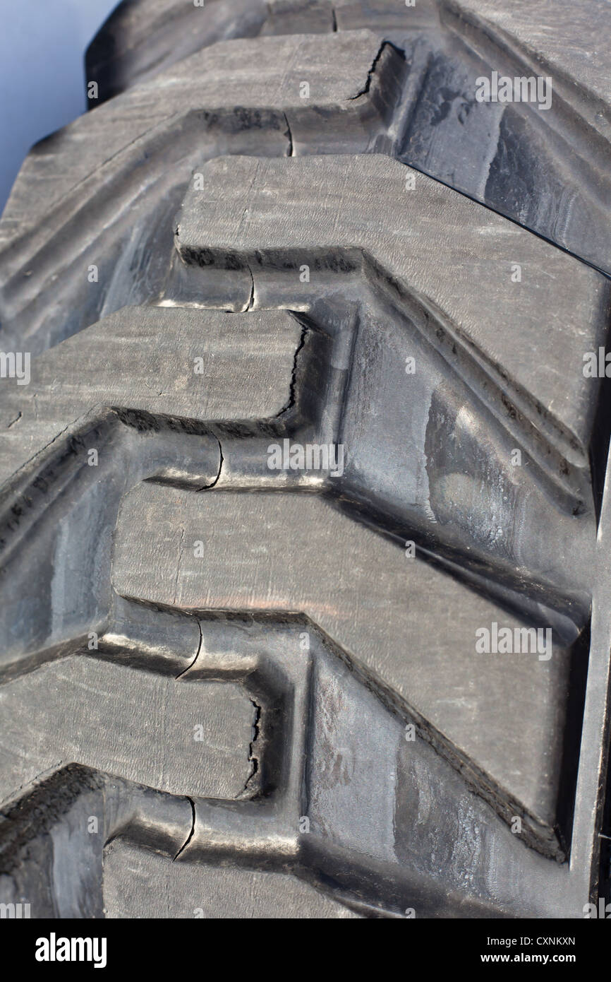 Giant old damaged truck tire. Vertical shot Stock Photo - Alamy