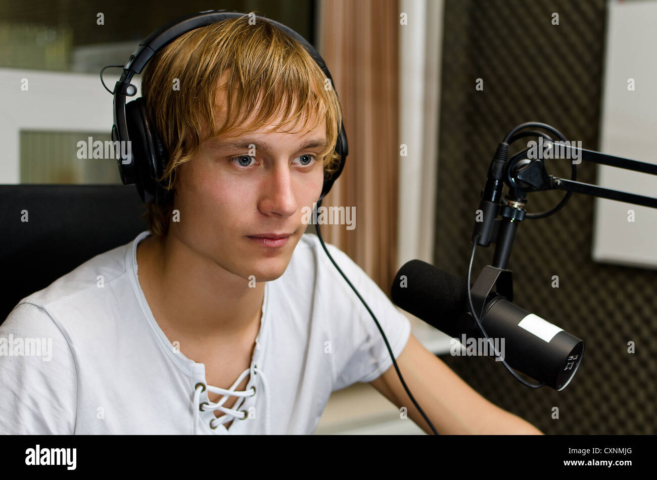 Portrait of male dj working in front of a microphone on the radio Stock ...