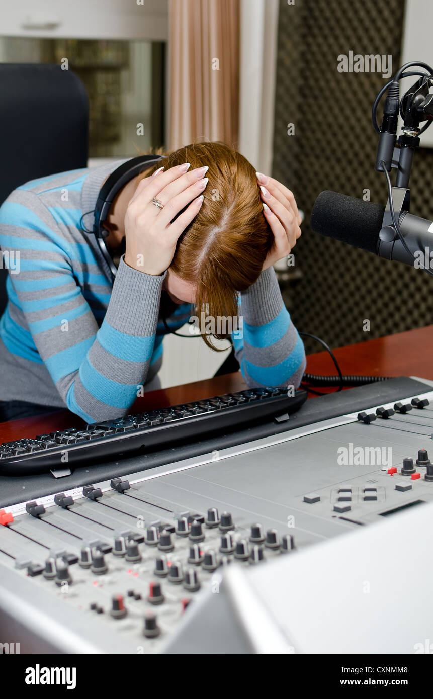 Portrait of female dj working in front of a microphone on the radio ...