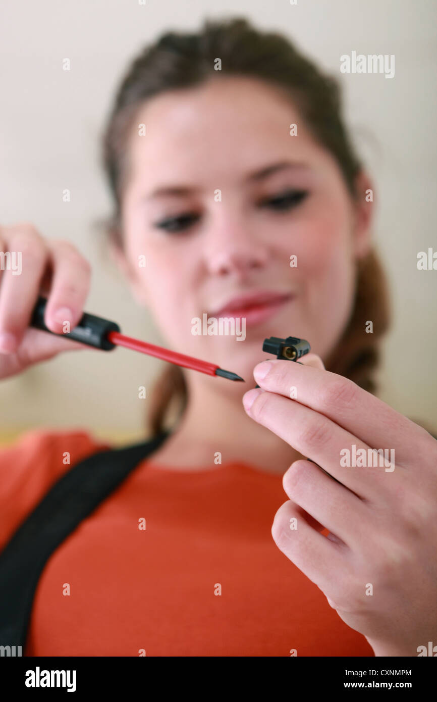 Woman using screwdriver Stock Photo - Alamy