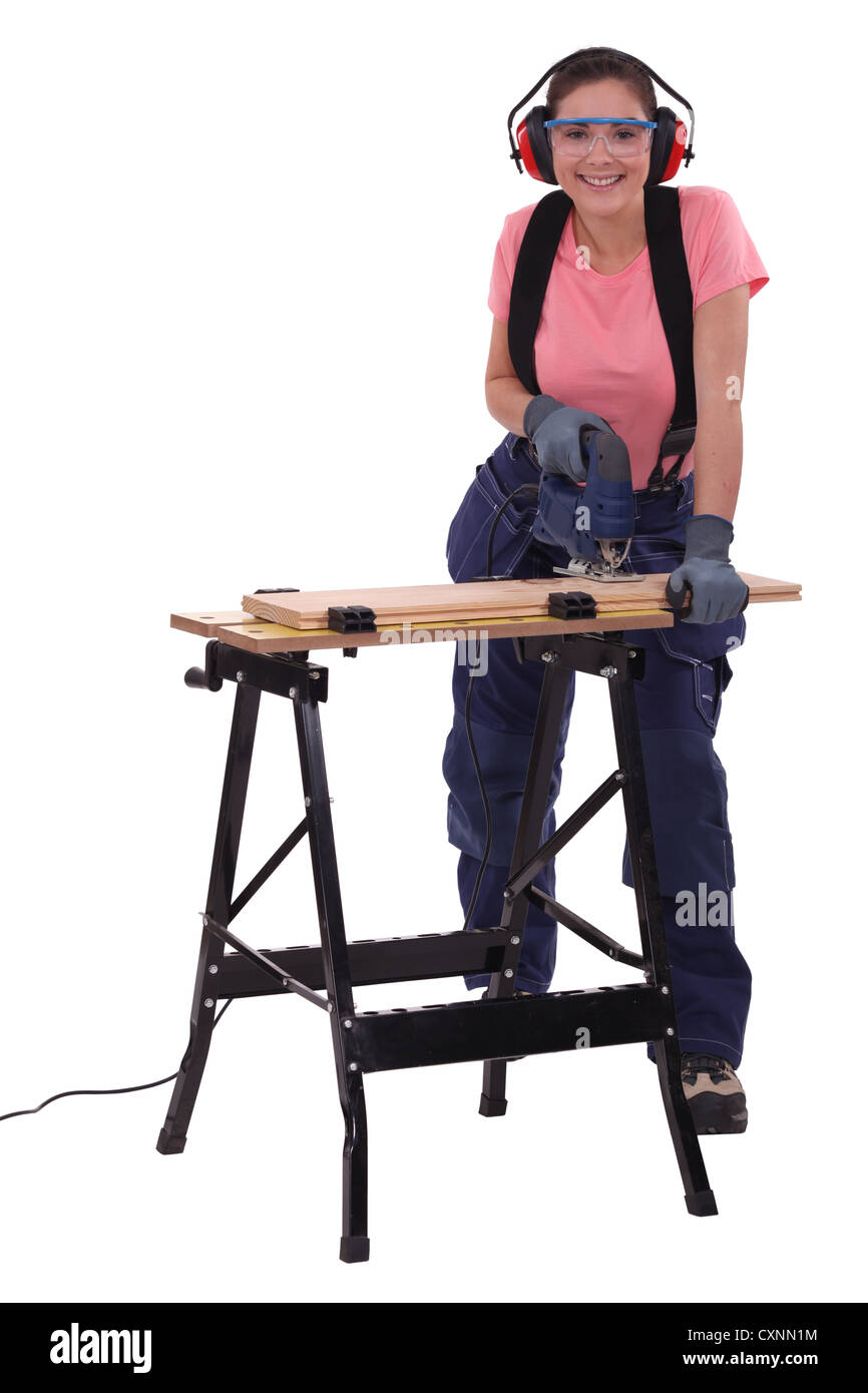 Female capenter cutting plank with electric saw Stock Photo - Alamy