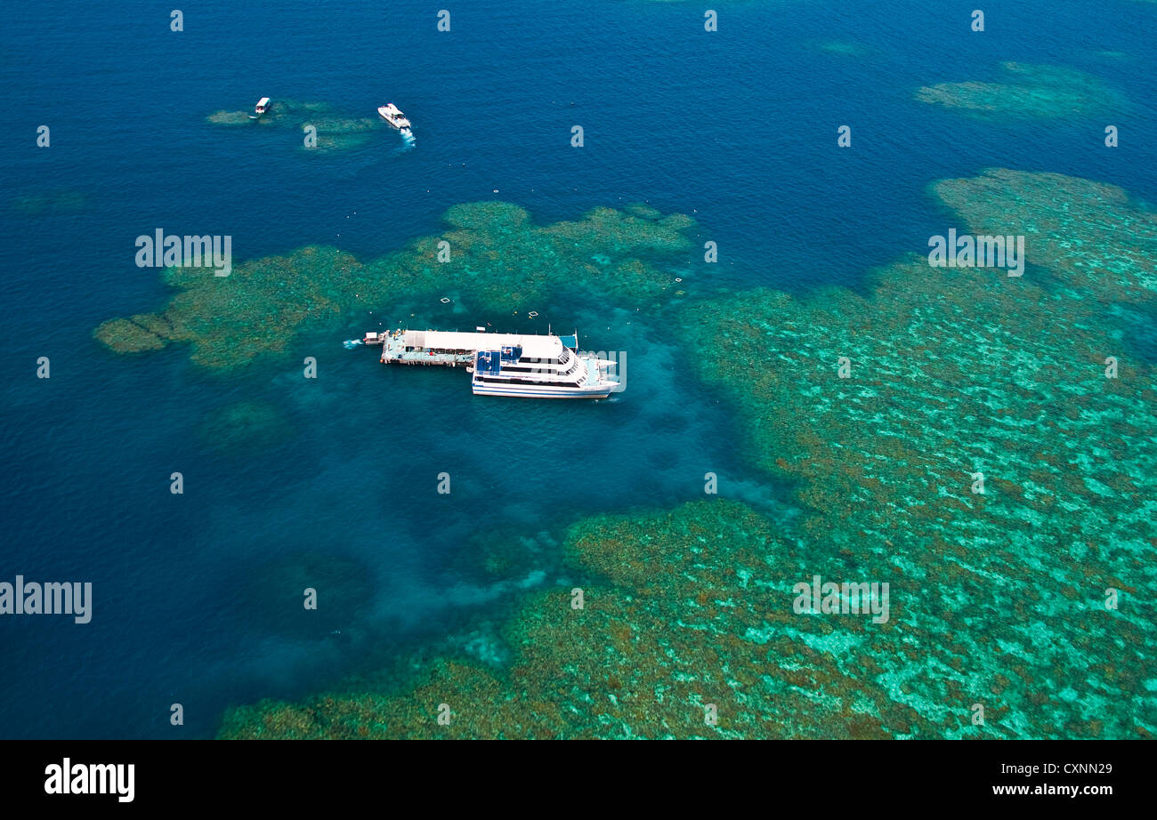Aerial view of a tour boat docked at a pontoon at the Great Barrier ...