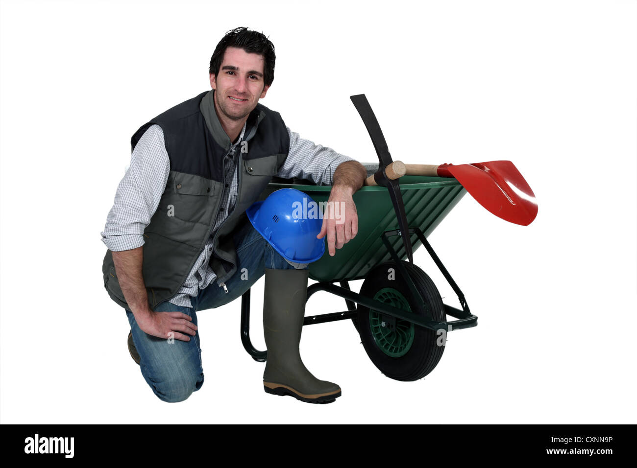 Construction worker with a wheelbarrow Stock Photo - Alamy