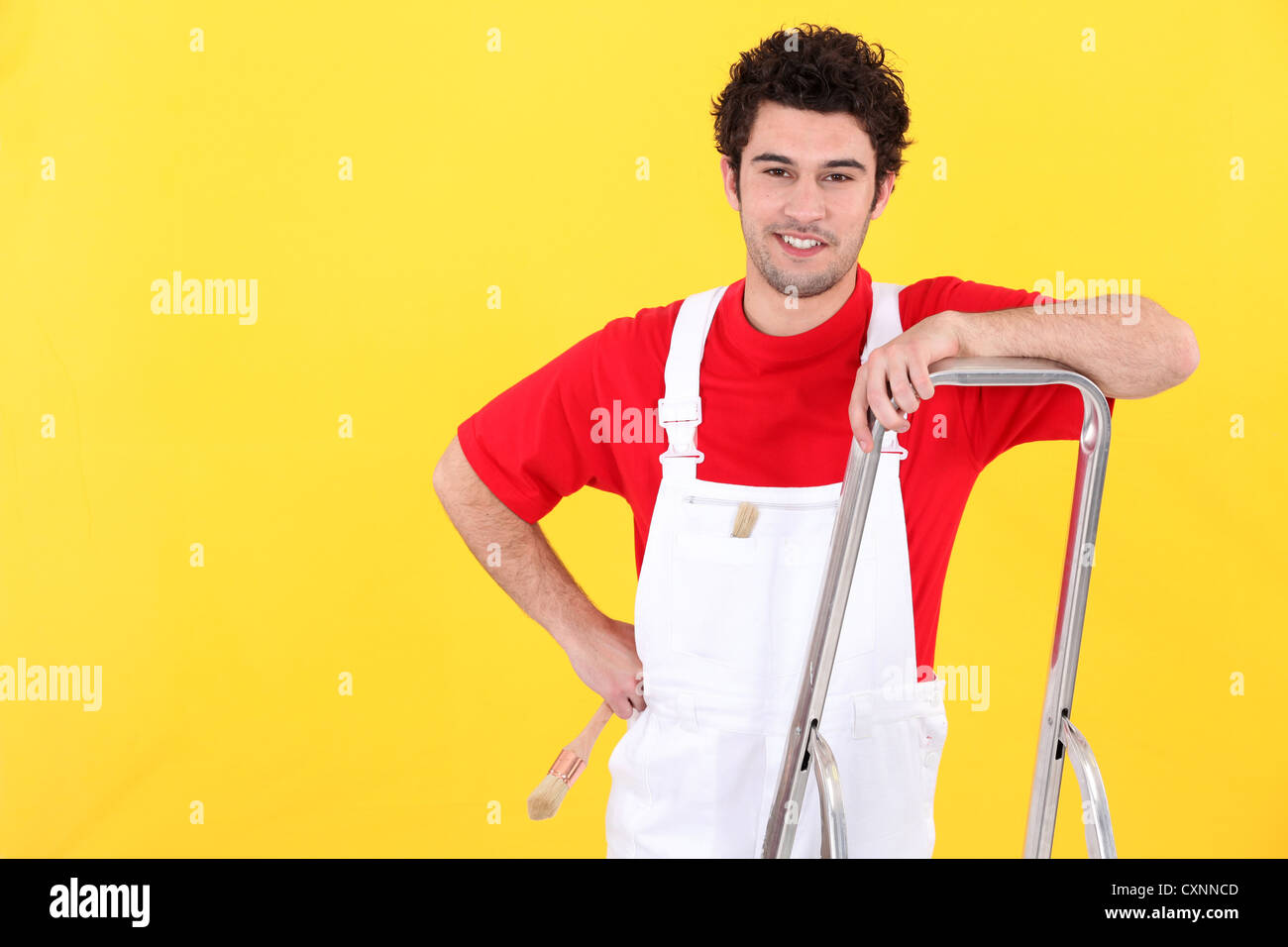 Painter leaning against ladder Stock Photo - Alamy