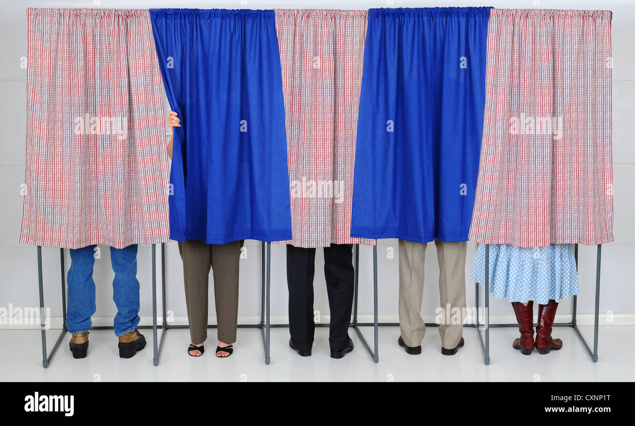 A row of five voting booths with men and women casting their ballots at ...