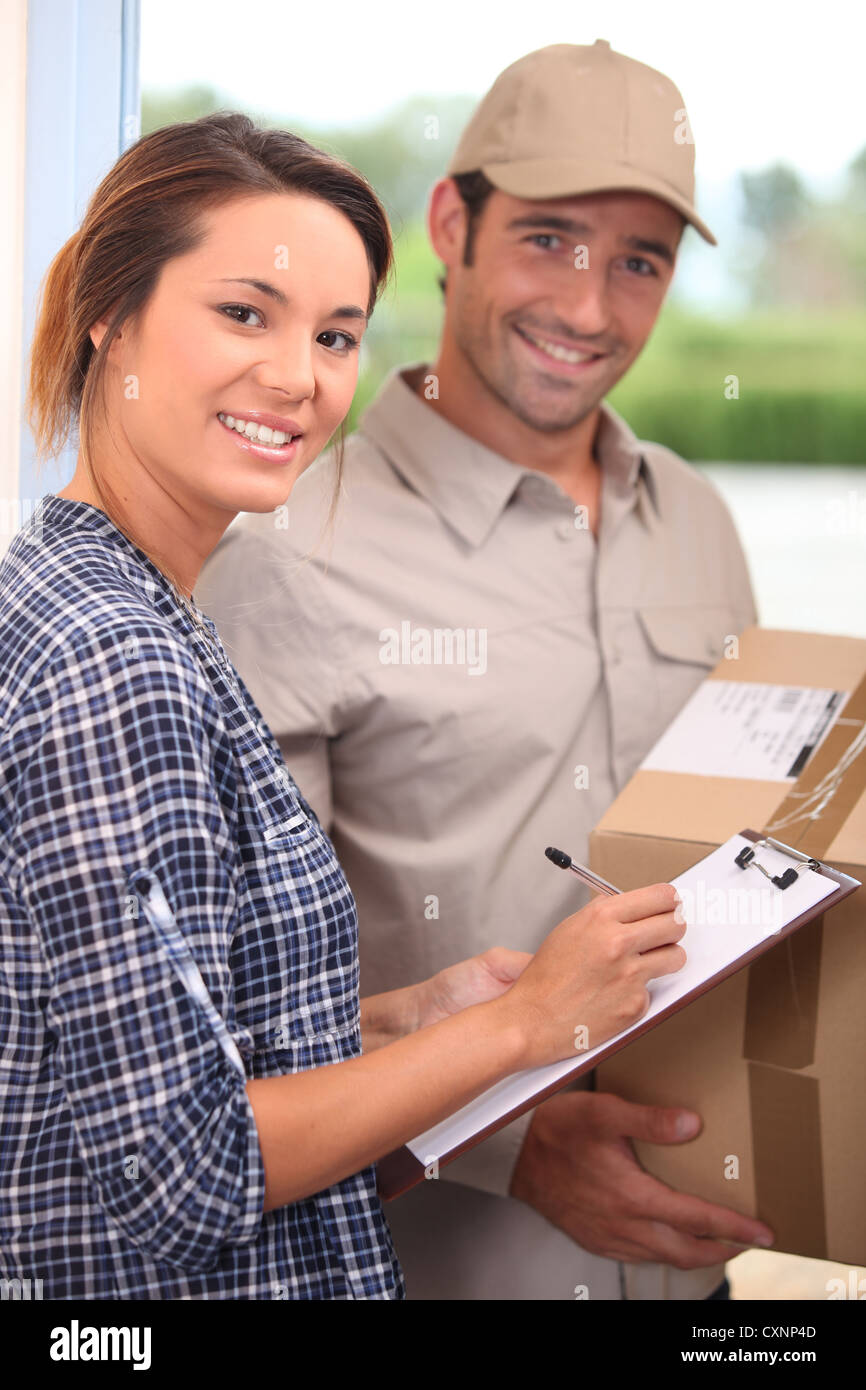 Courier with a signed-for delivery Stock Photo - Alamy