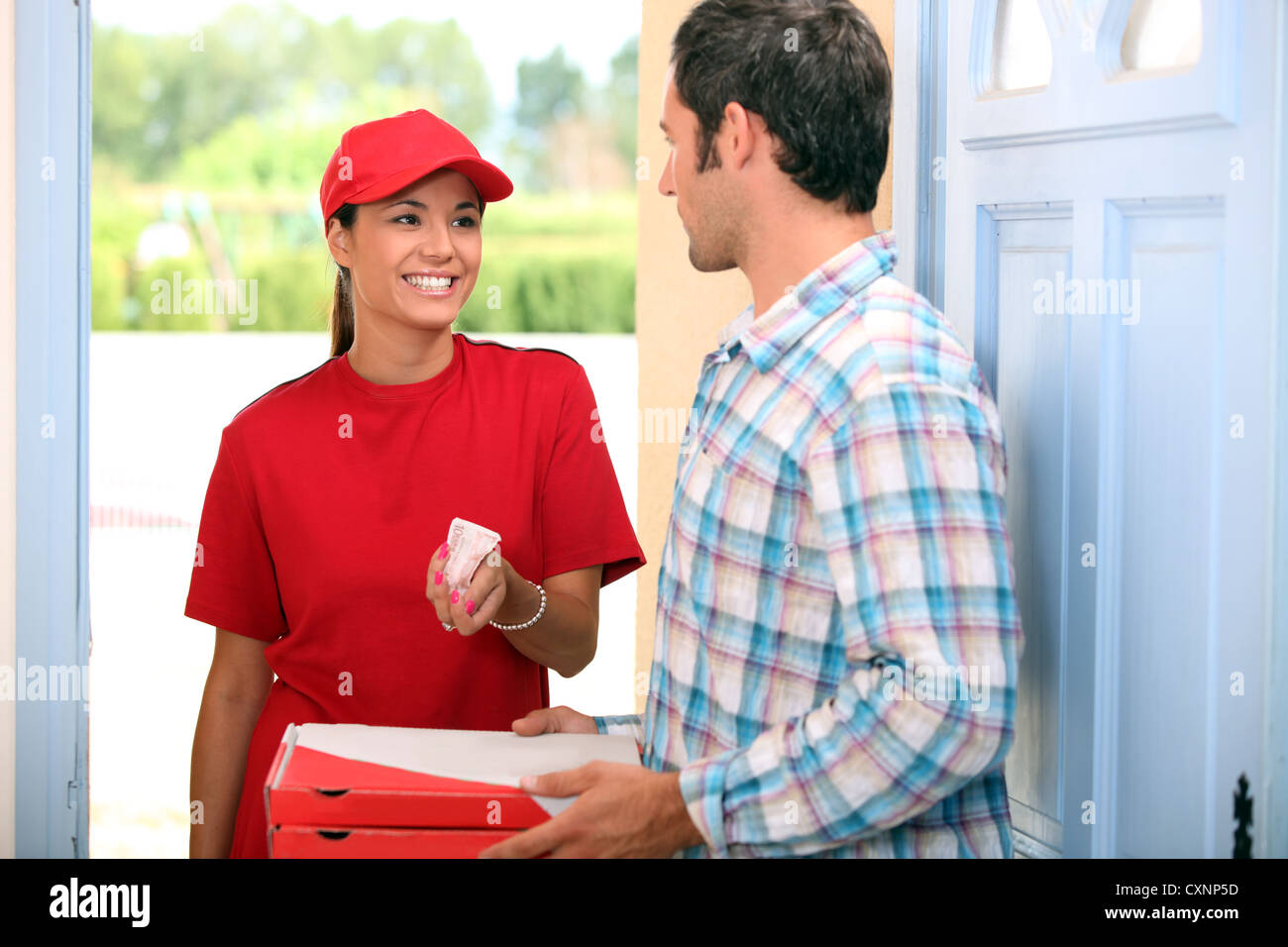 Woman delivering pizza Stock Photo - Alamy