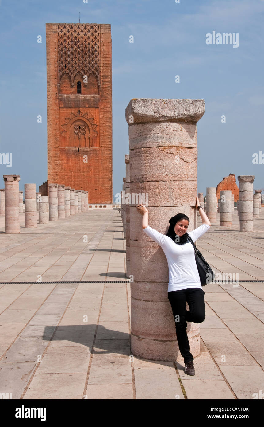 Muslim woman with column in square of mosque and Hassan Tower in Rabat ...