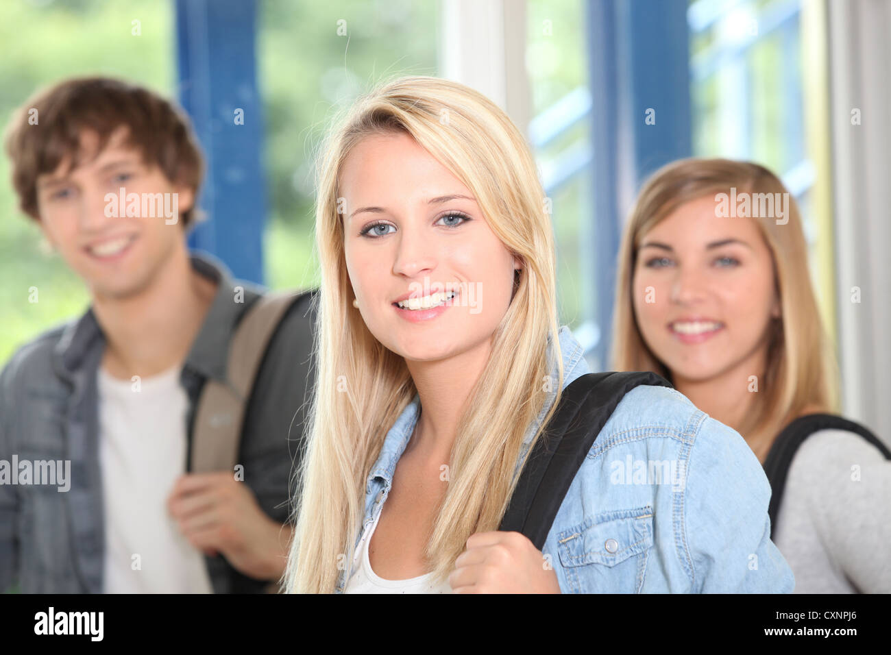 Three happy college students Stock Photo - Alamy