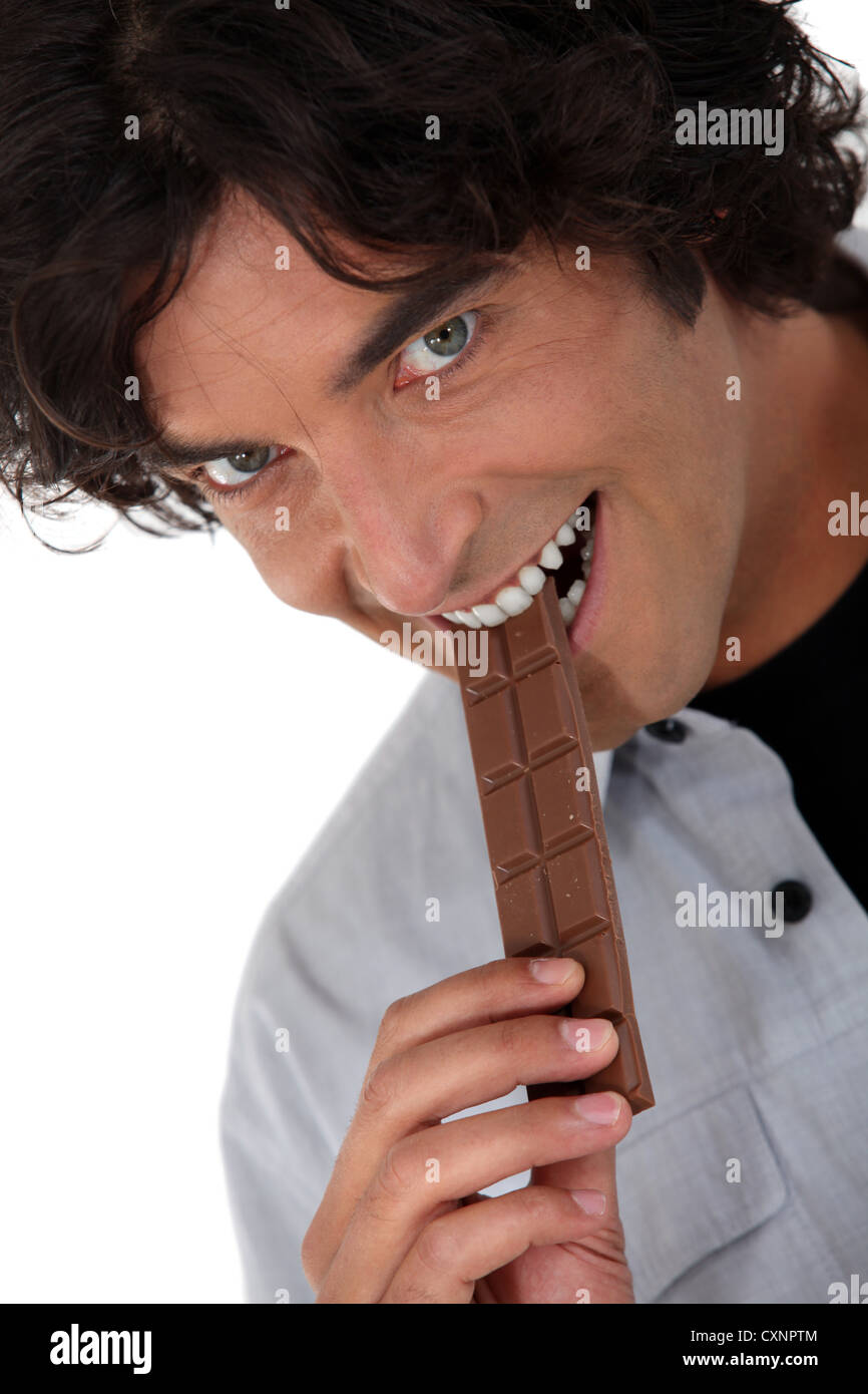 Man eating chocolate Stock Photo - Alamy