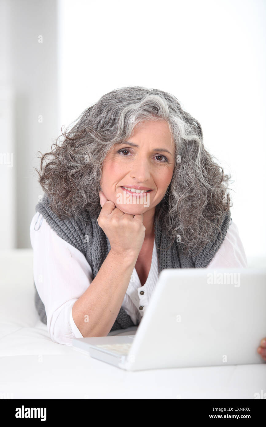 Older woman using a laptop computer Stock Photo - Alamy