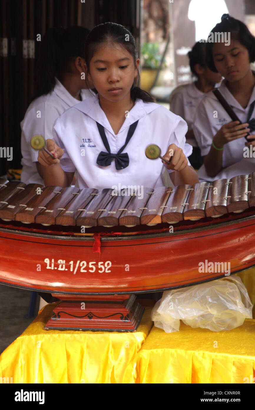 Thai student performing Ranat Ek (traditional Thai xylophone Stock ...