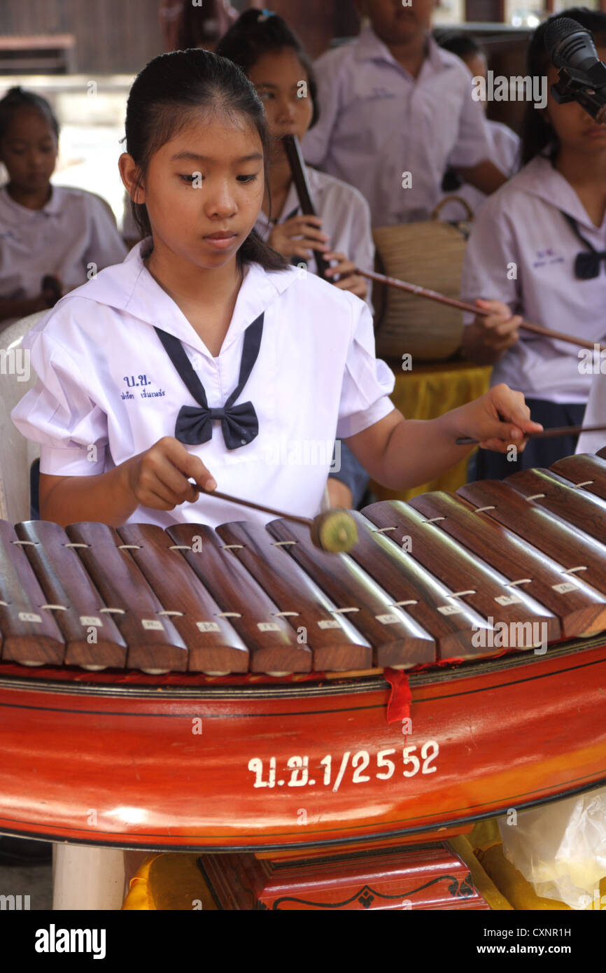 Thai student performing Ranat Ek (traditional Thai xylophone Stock ...
