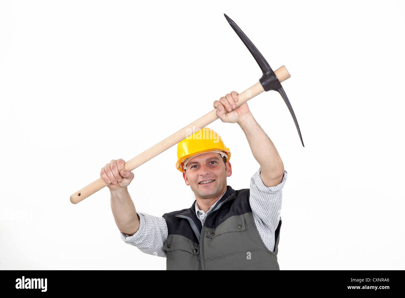 Construction worker carrying a pickaxe Stock Photo - Alamy