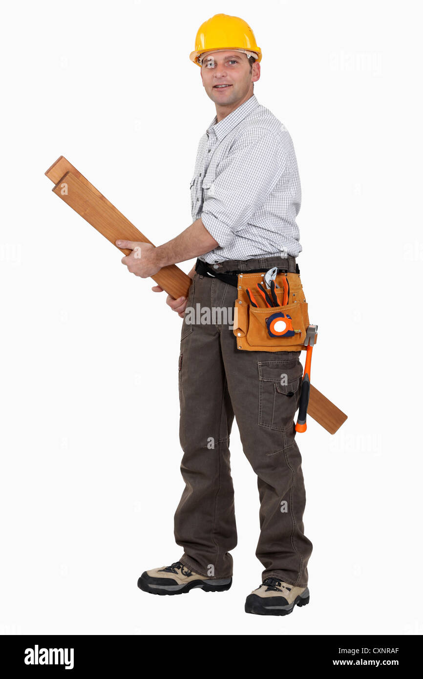 A carpenter carrying planks Stock Photo - Alamy