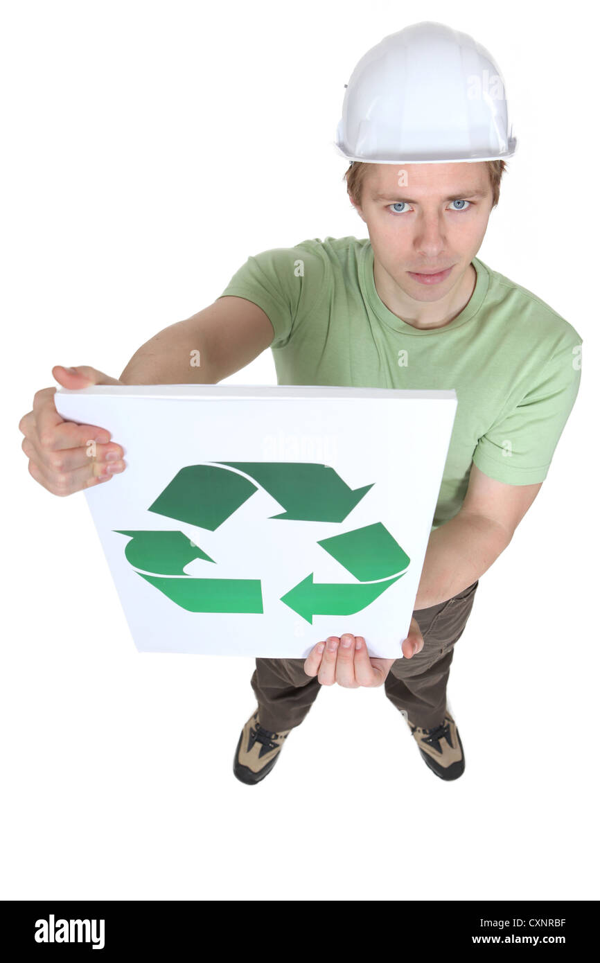 Young man holding sign with symbol of recycling Stock Photo - Alamy