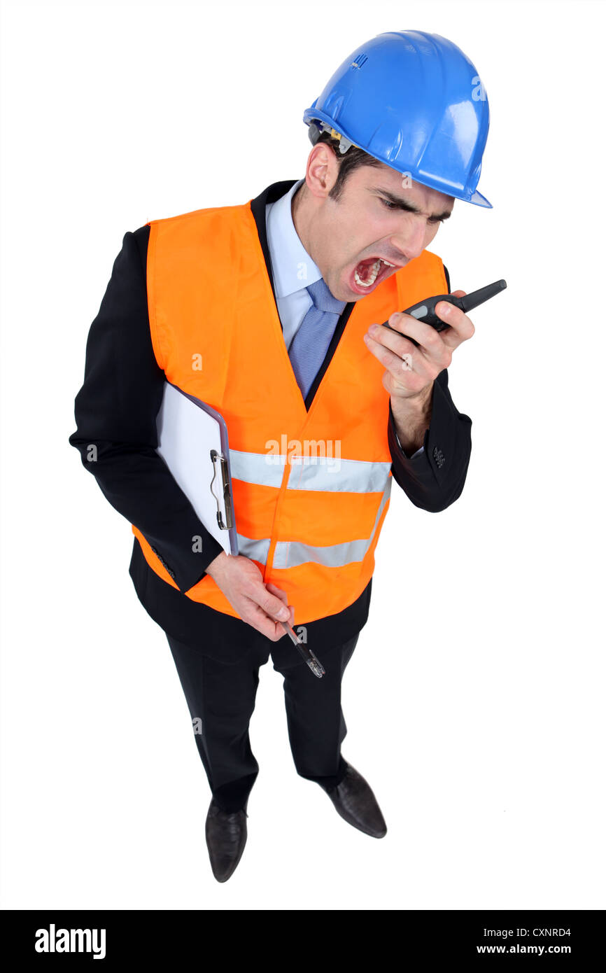 Engineer shouting into a two-way radio Stock Photo - Alamy