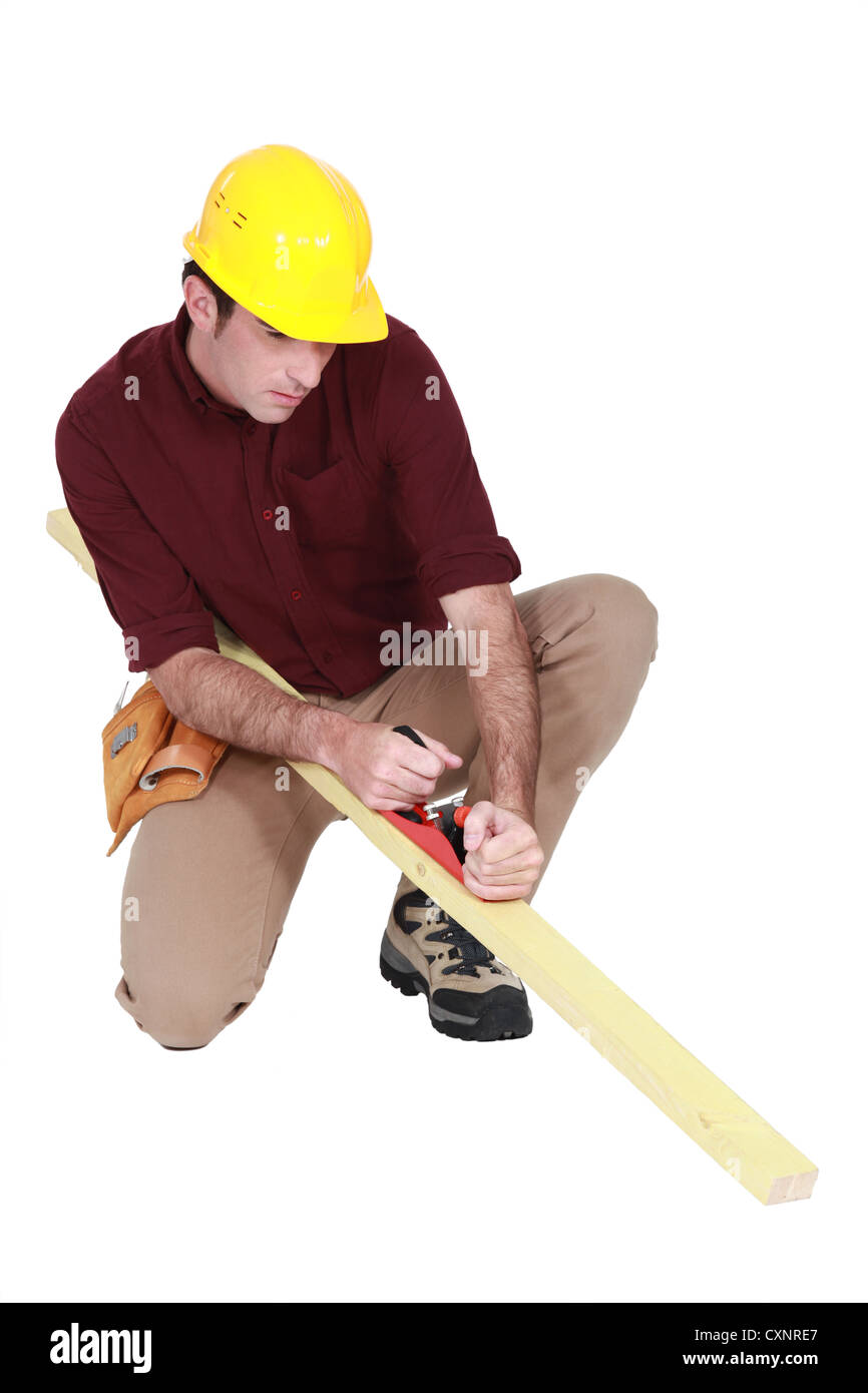 Carpenter using a plane Stock Photo - Alamy