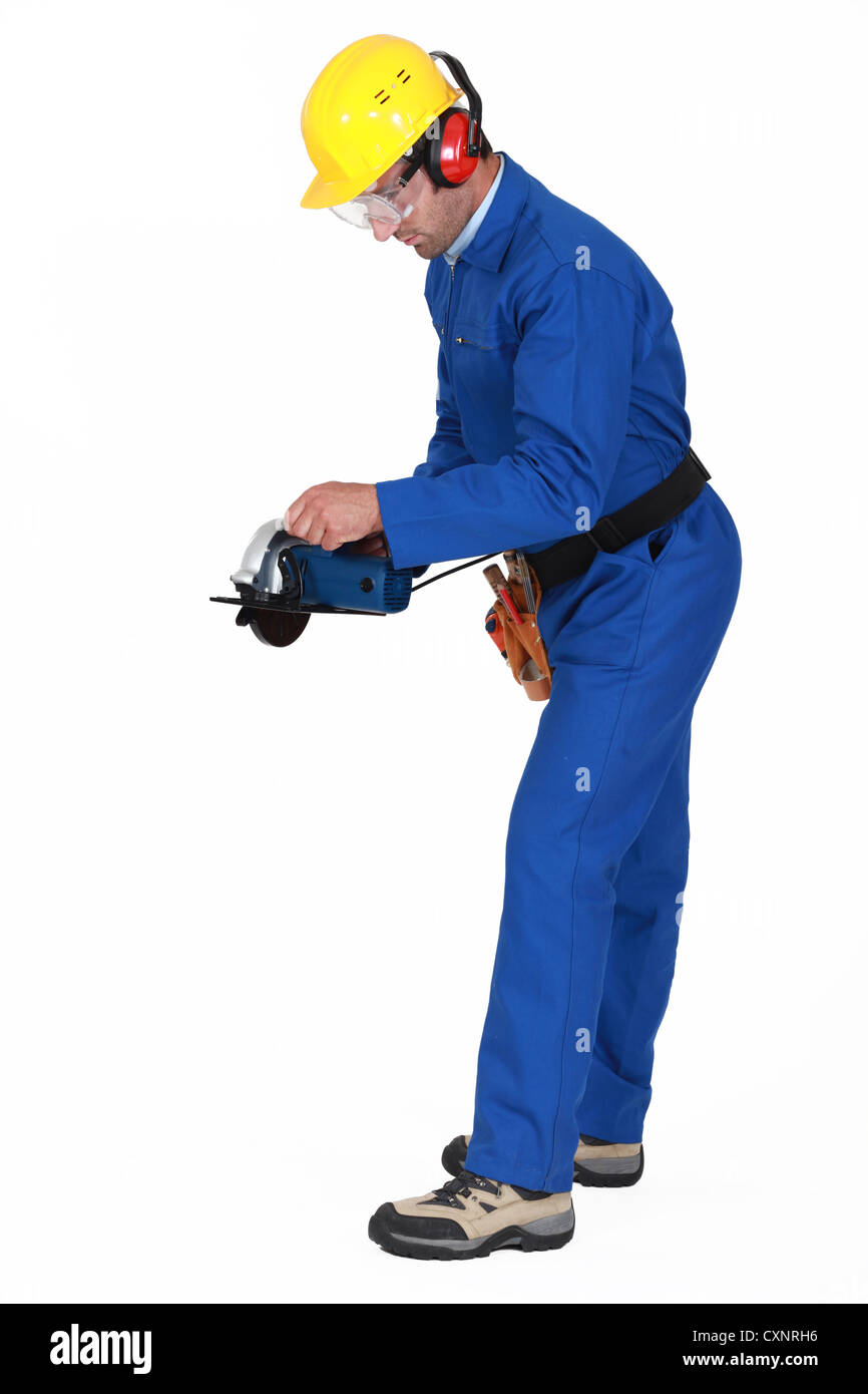 Tradesman holding a circular saw Stock Photo - Alamy