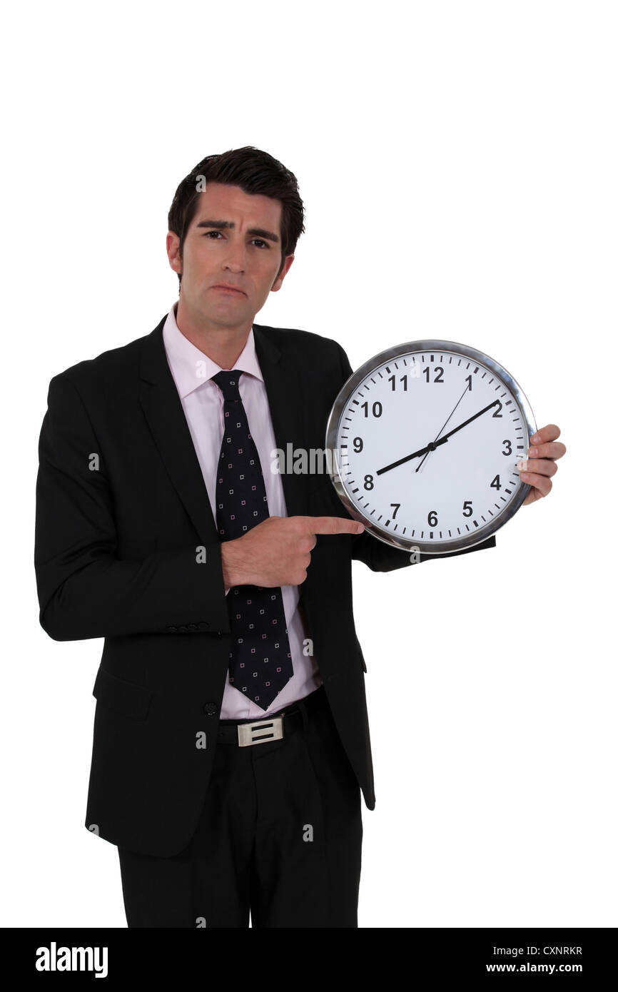 Man pointing at clock Stock Photo - Alamy