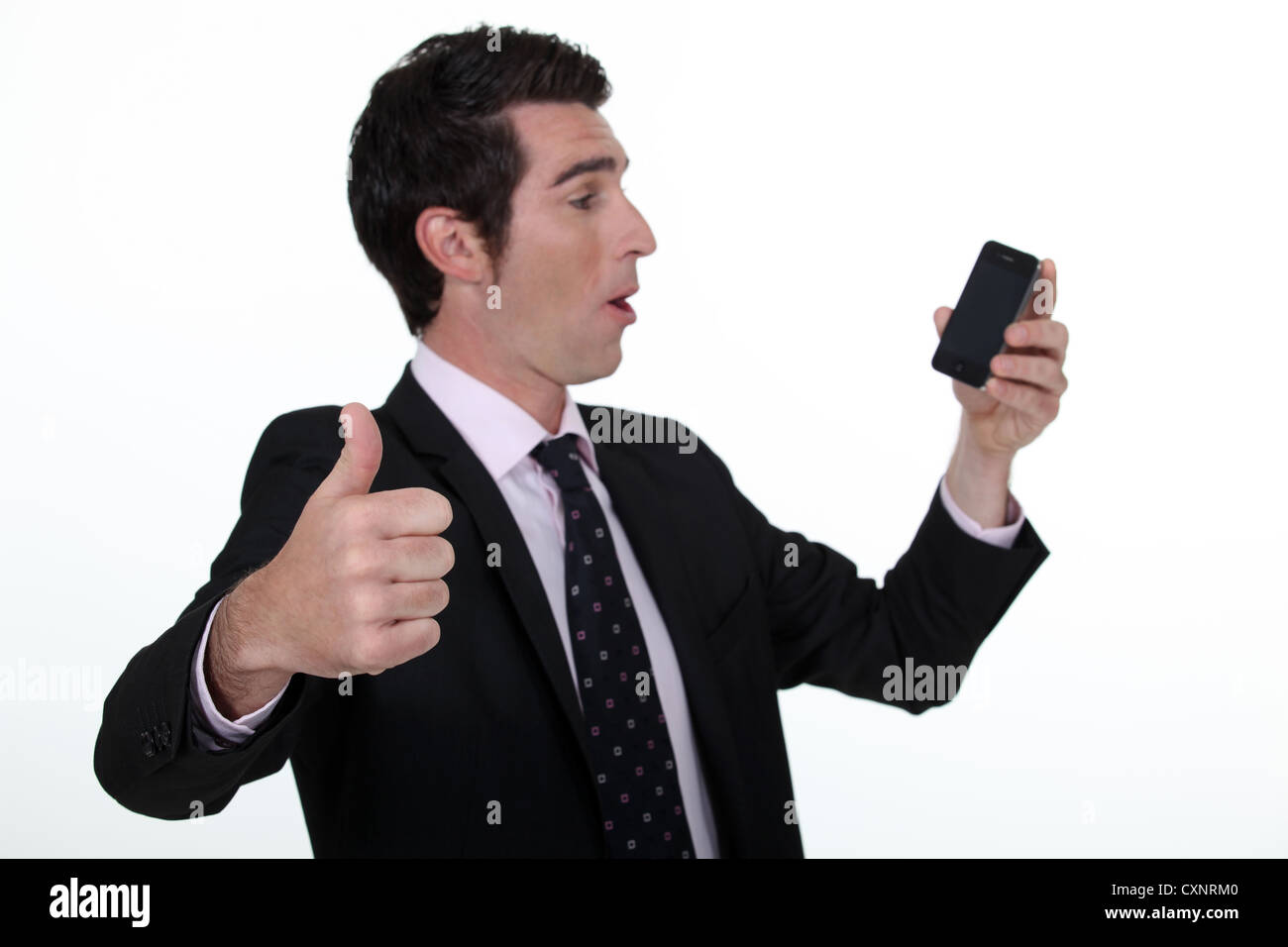 Thumbs up from a businessman with a cellphone Stock Photo - Alamy