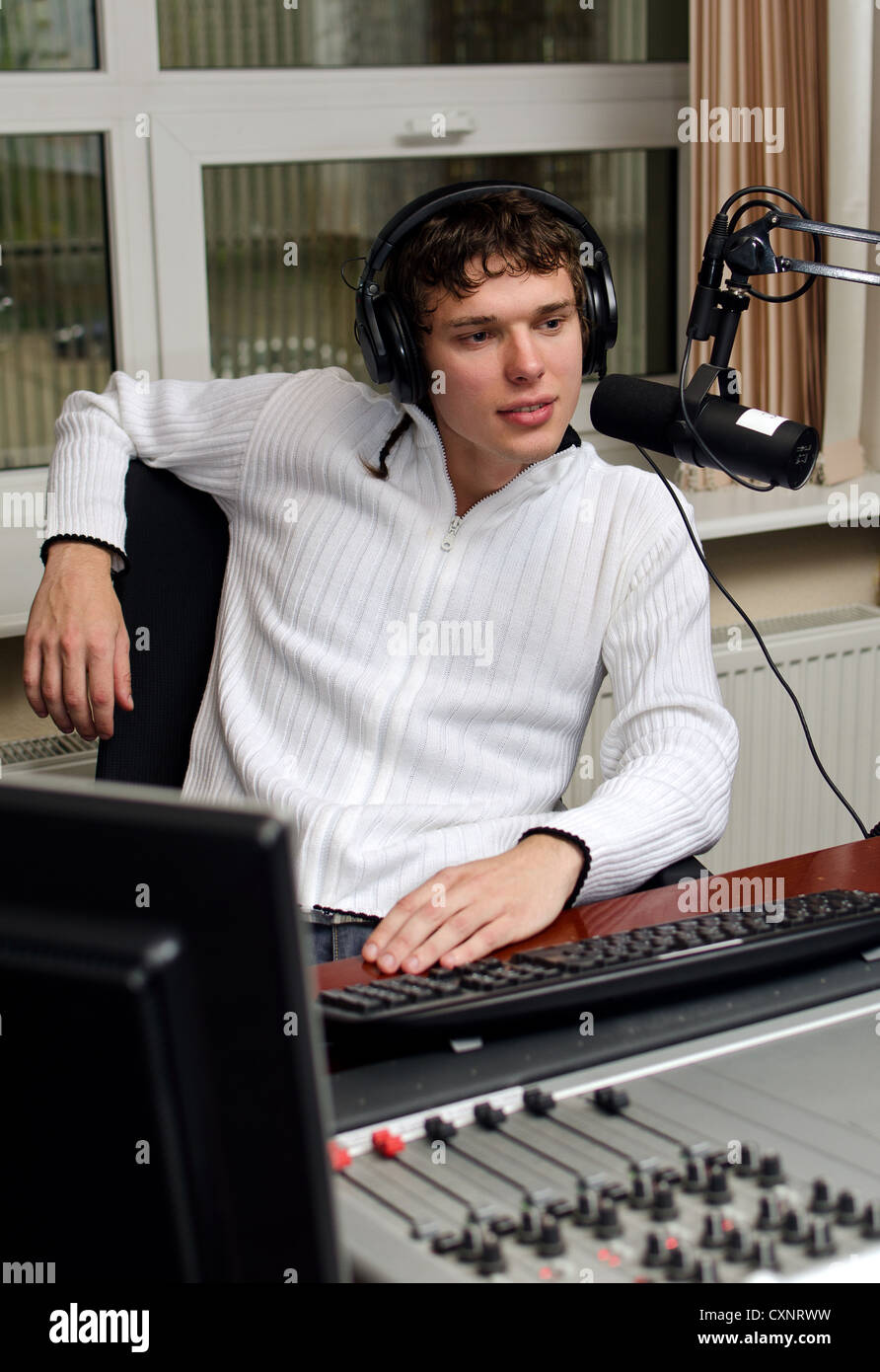 Portrait of male dj working in front of a microphone on the radio Stock ...