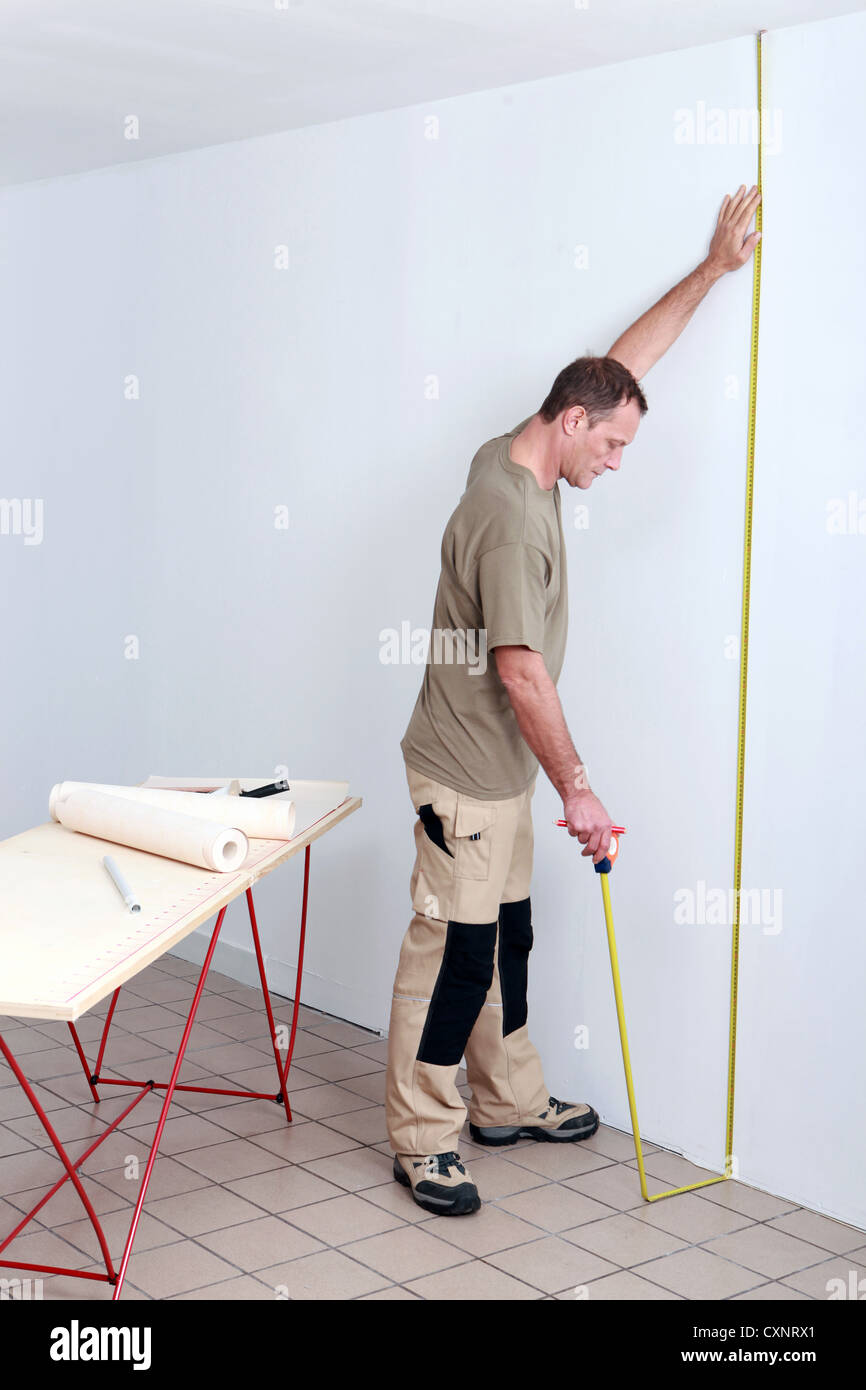 Man measuring wall Stock Photo - Alamy