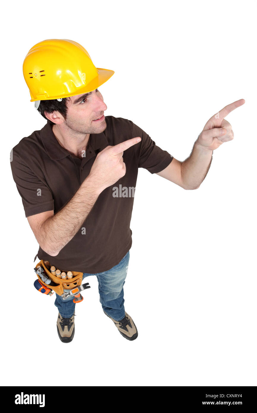 Builder pointing with both hands Stock Photo - Alamy