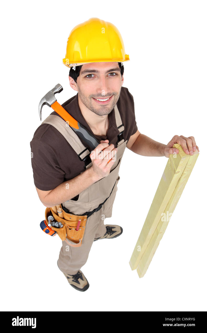 Carpenter with wood and a hammer Stock Photo - Alamy