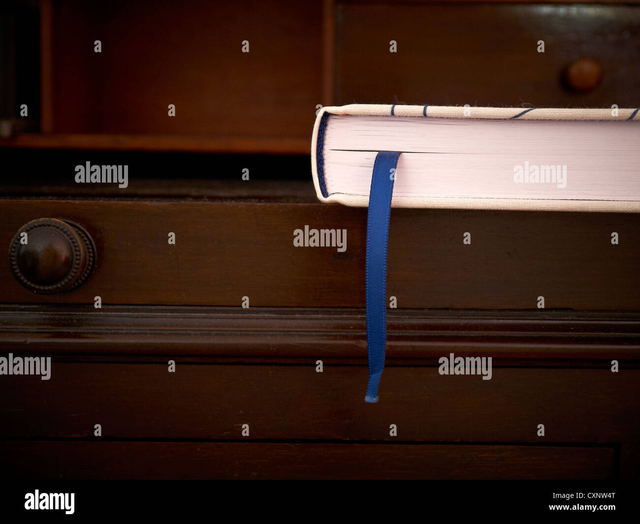 Closed book with blue bookmark Stock Photo - Alamy