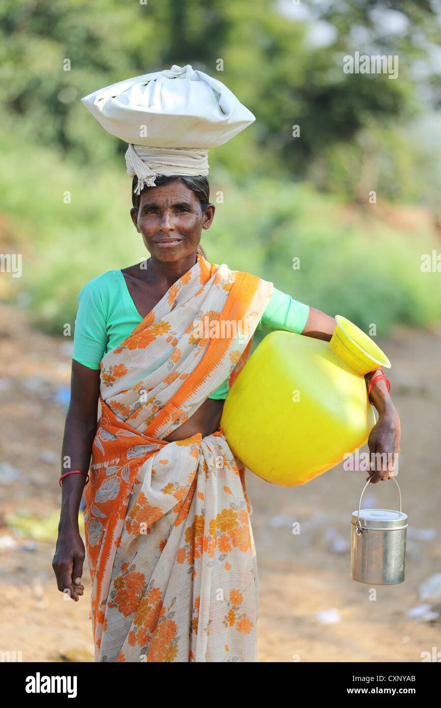 Indian woman carrying pot and basket Andhra Pradesh south India Stock ...