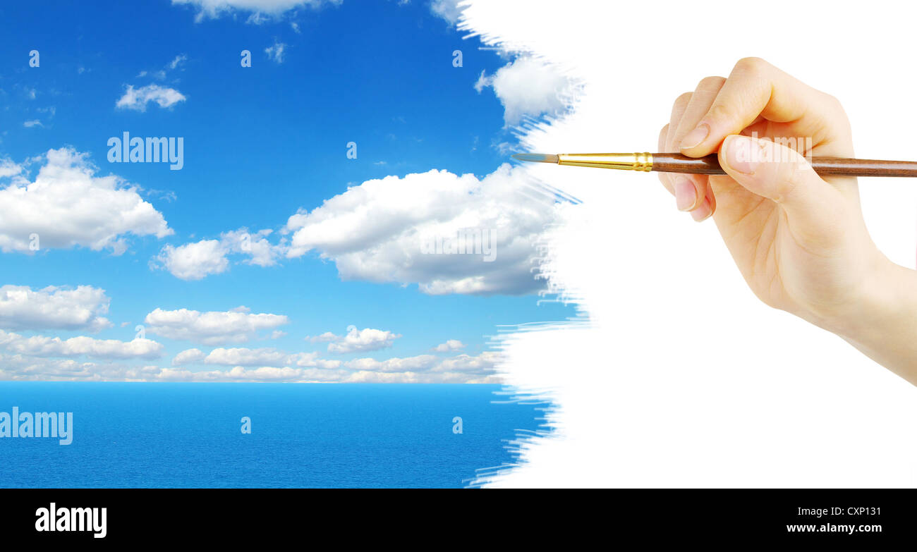 hand with a brush paints a beautiful landscape Stock Photo - Alamy