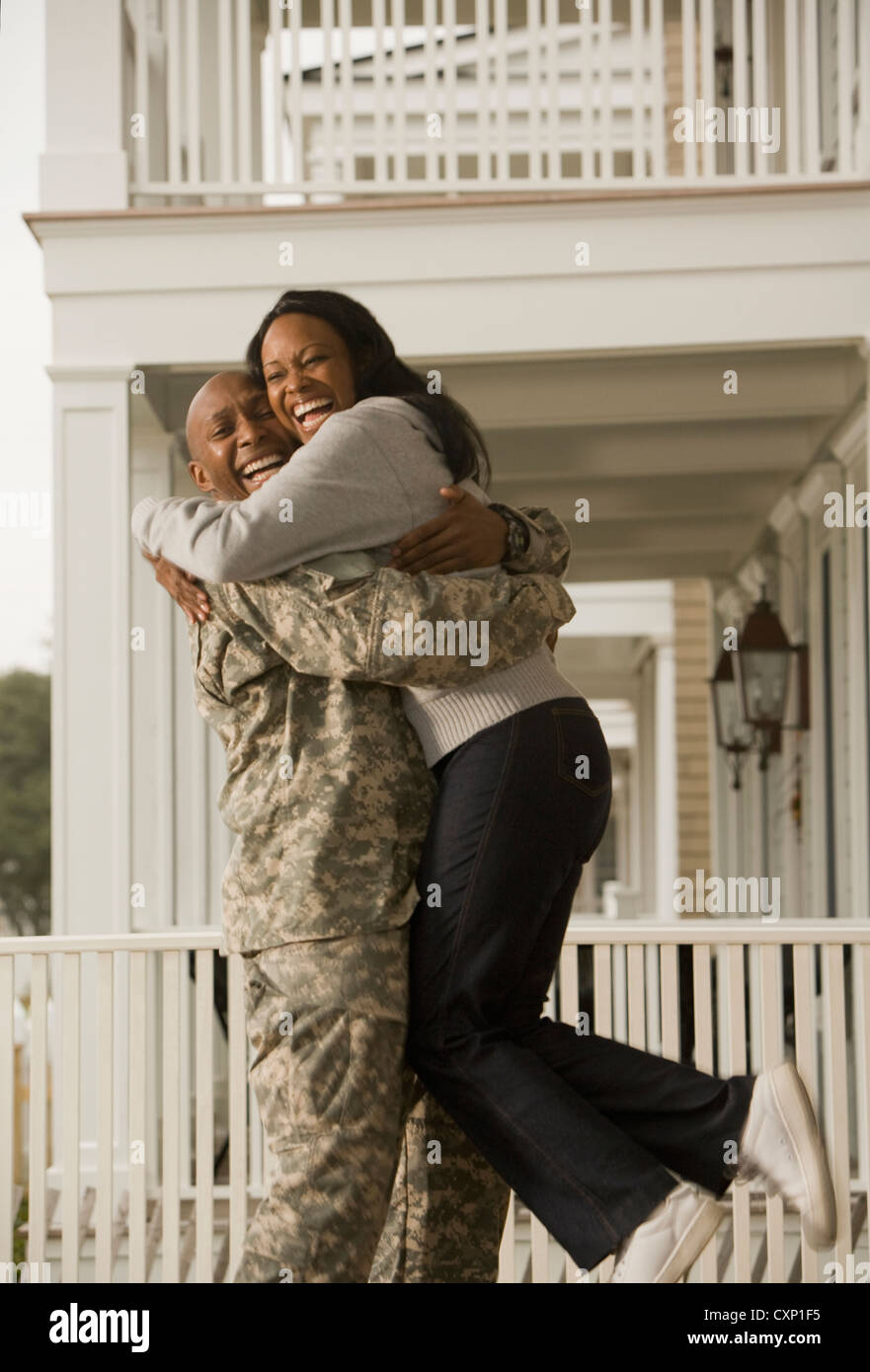 African soldier hugging girlfriend Stock Photo - Alamy