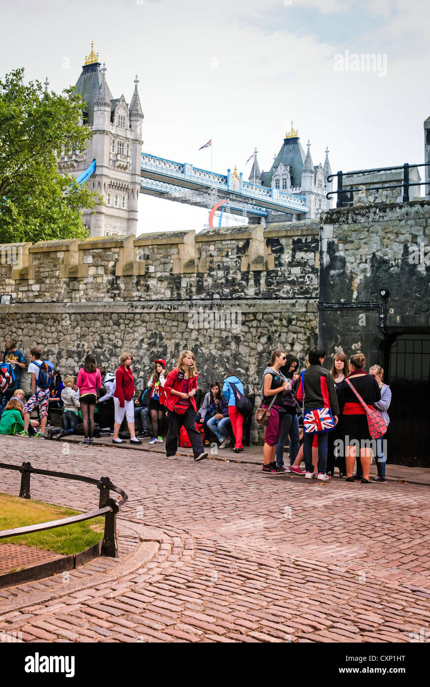 Tourists of all ages around the Tower of London and Tower Bridge in ...